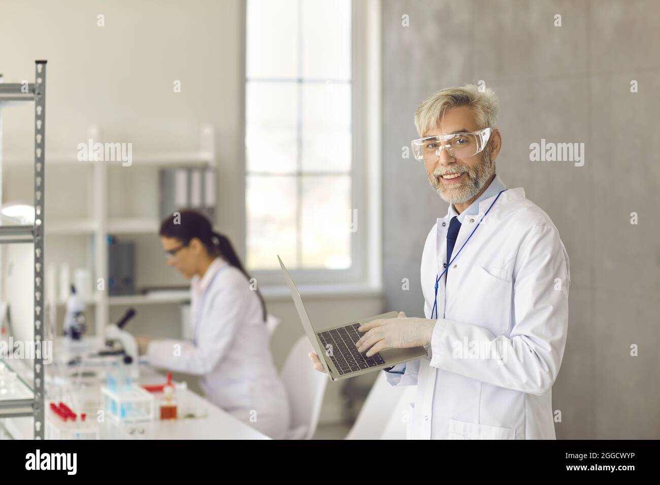 Portrait of a doctor scientist working in a research laboratory holding ...