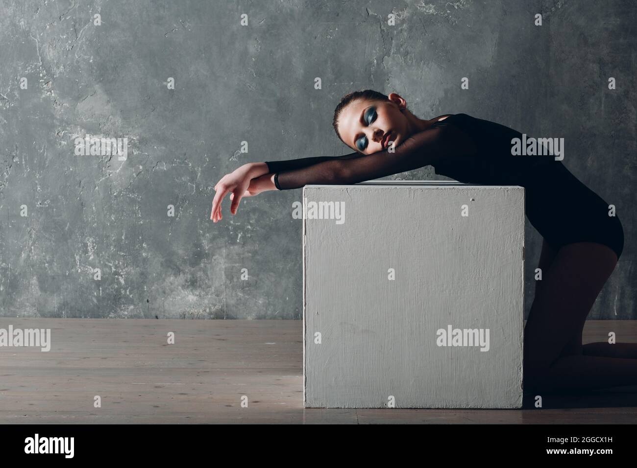 Young girl professional gymnast woman rhythmic gymnastics relaxing with ...