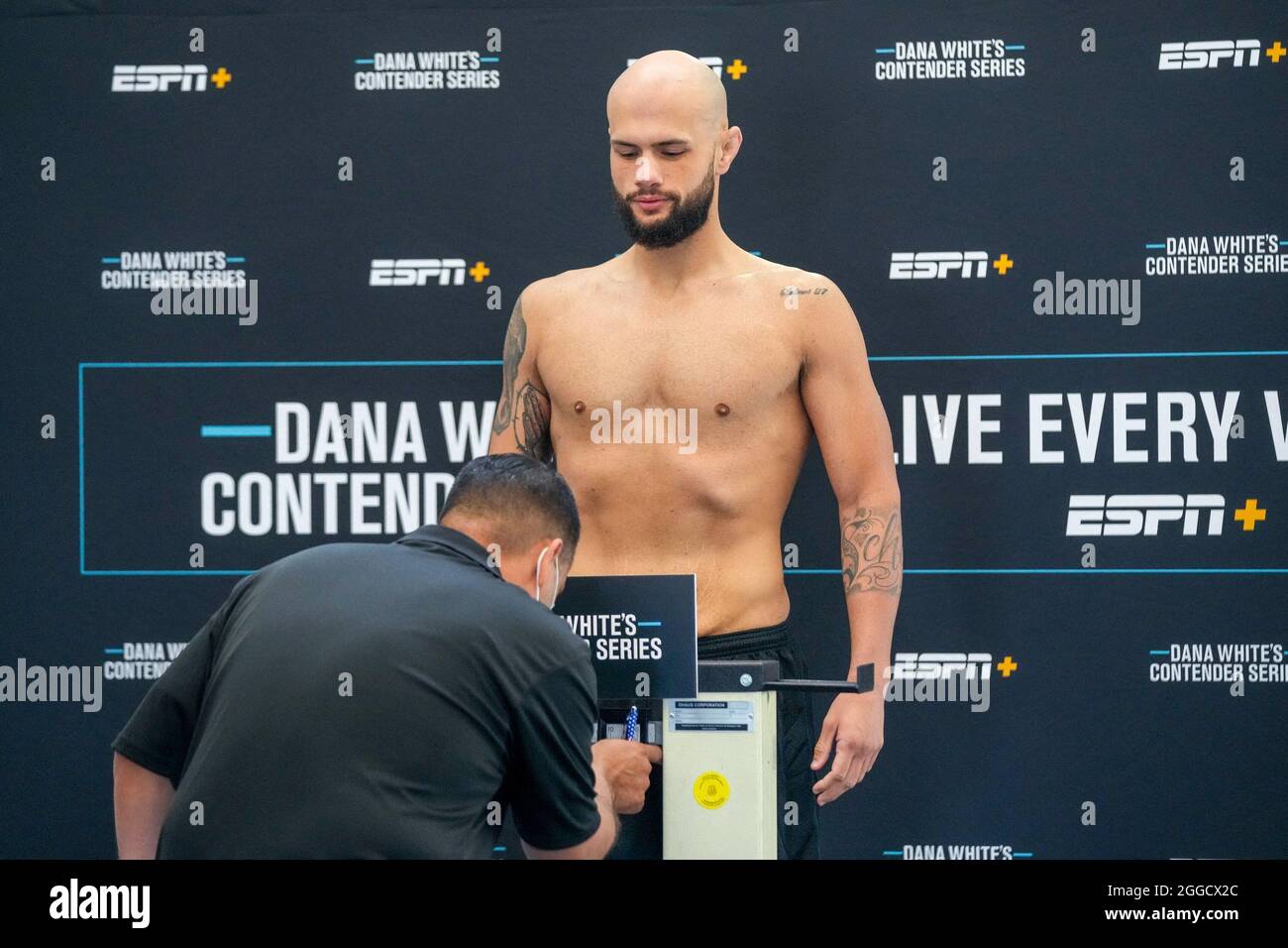 Matheus Scheffel steps on the scale for the official weigh-ins at ...