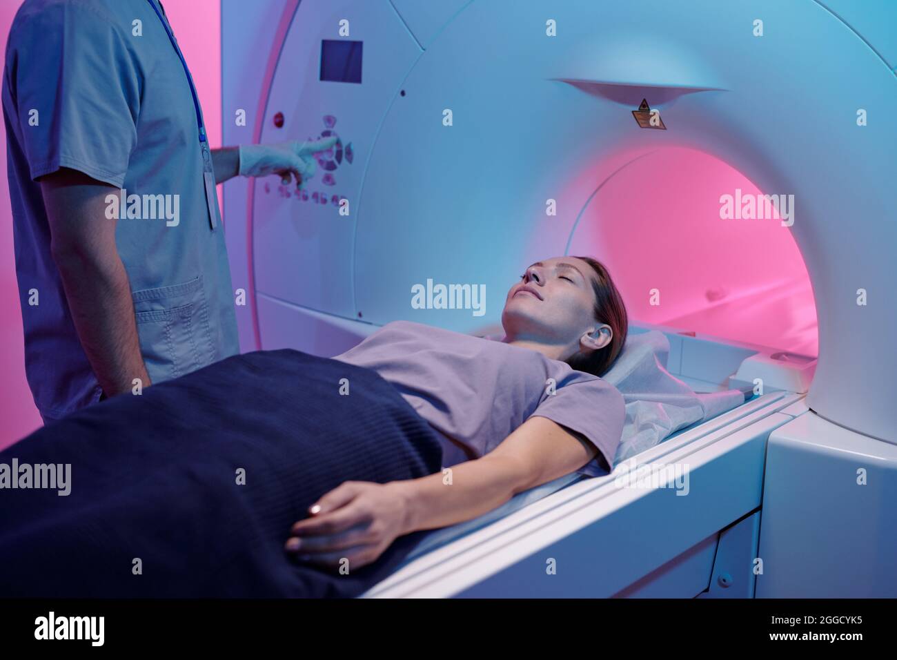 Young woman with her eyes closed waiting for start of mri scan ...