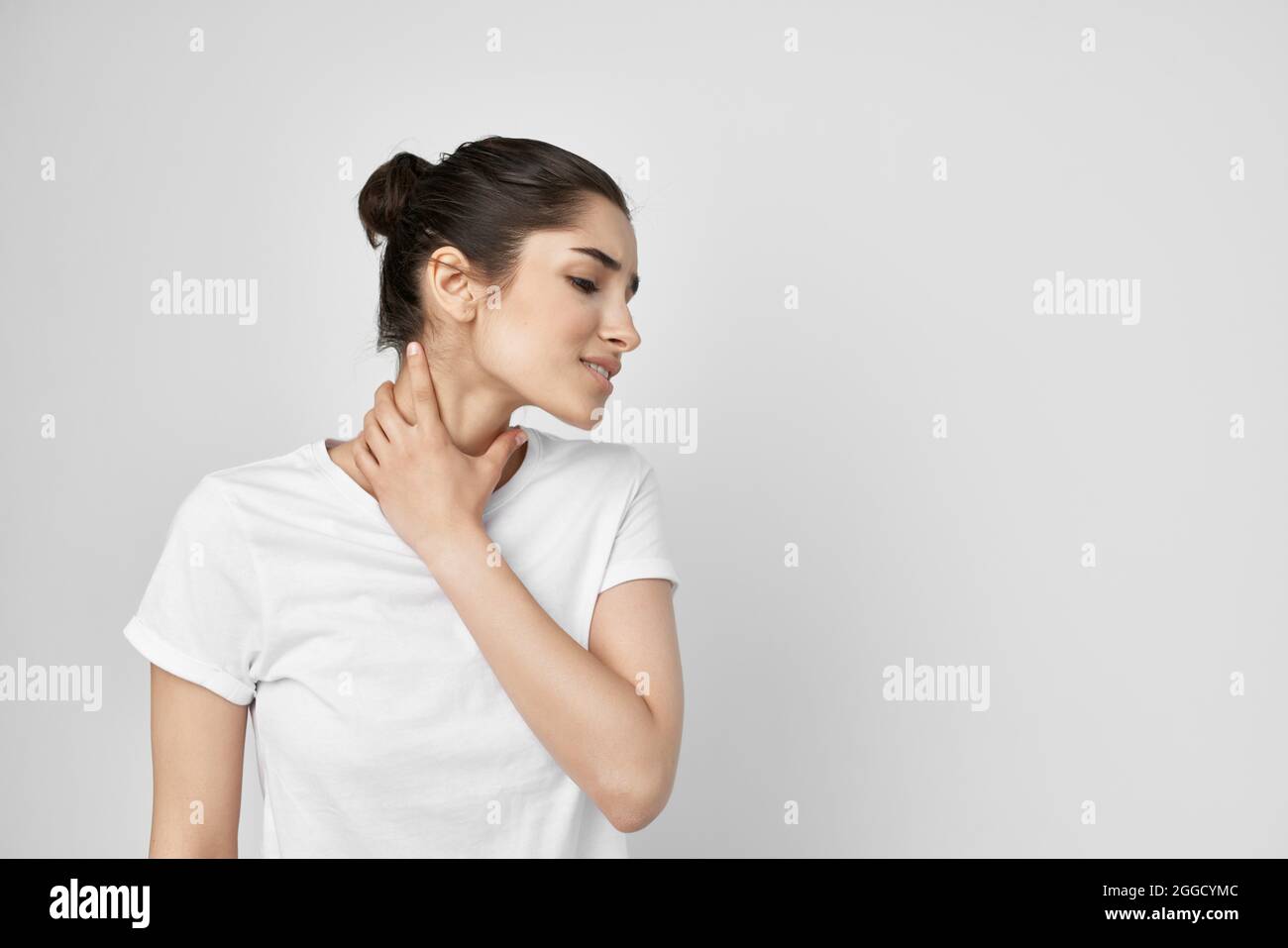 brunette holding on to the neck health care health problems Stock Photo ...