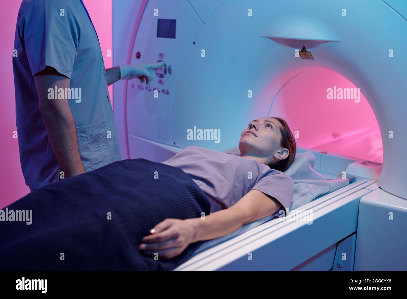 Young woman on medical table moving into mri scan machine for medical ...