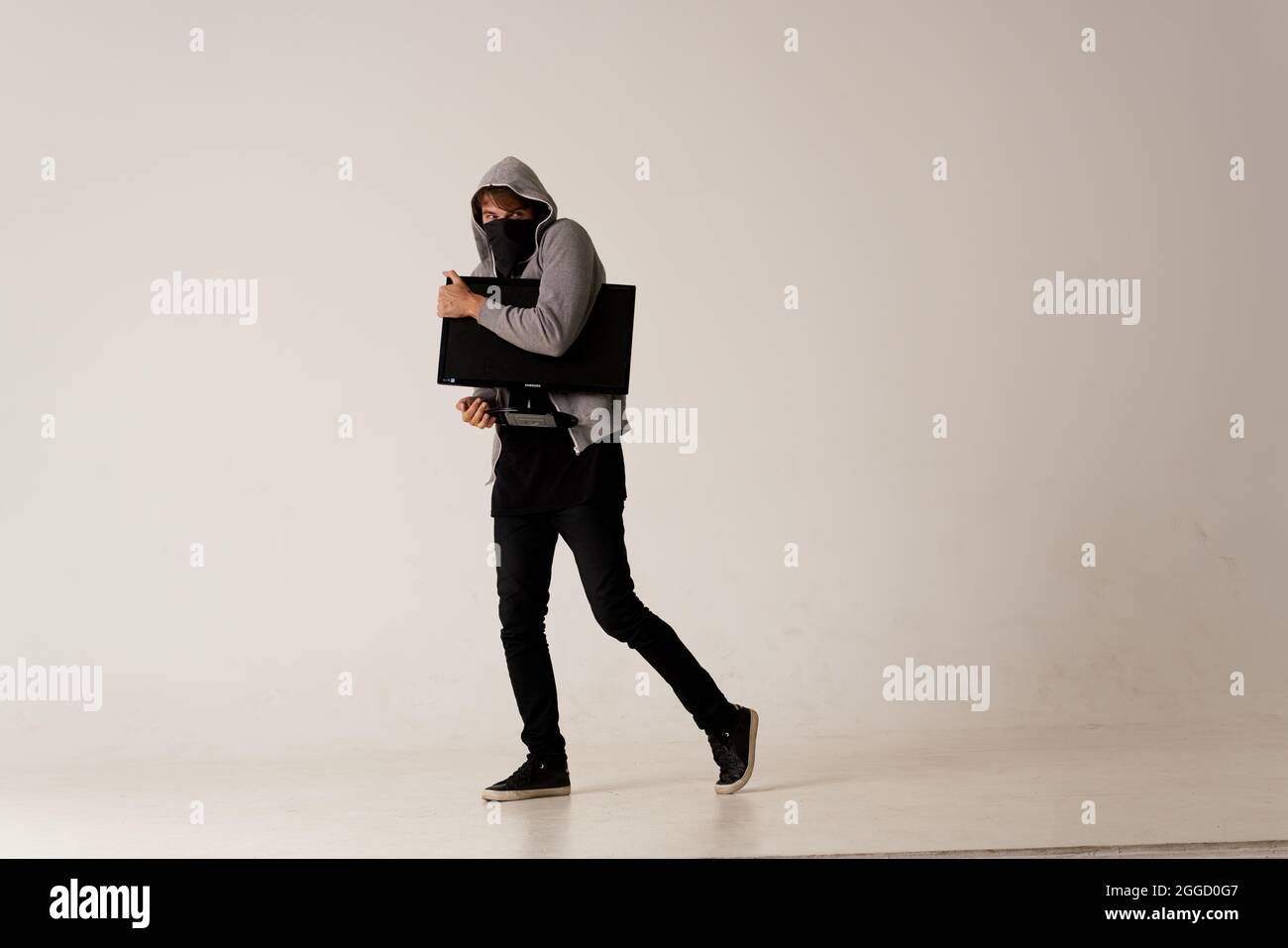 a man with a monitor in his hands steals a computer anonymity Hacker ...