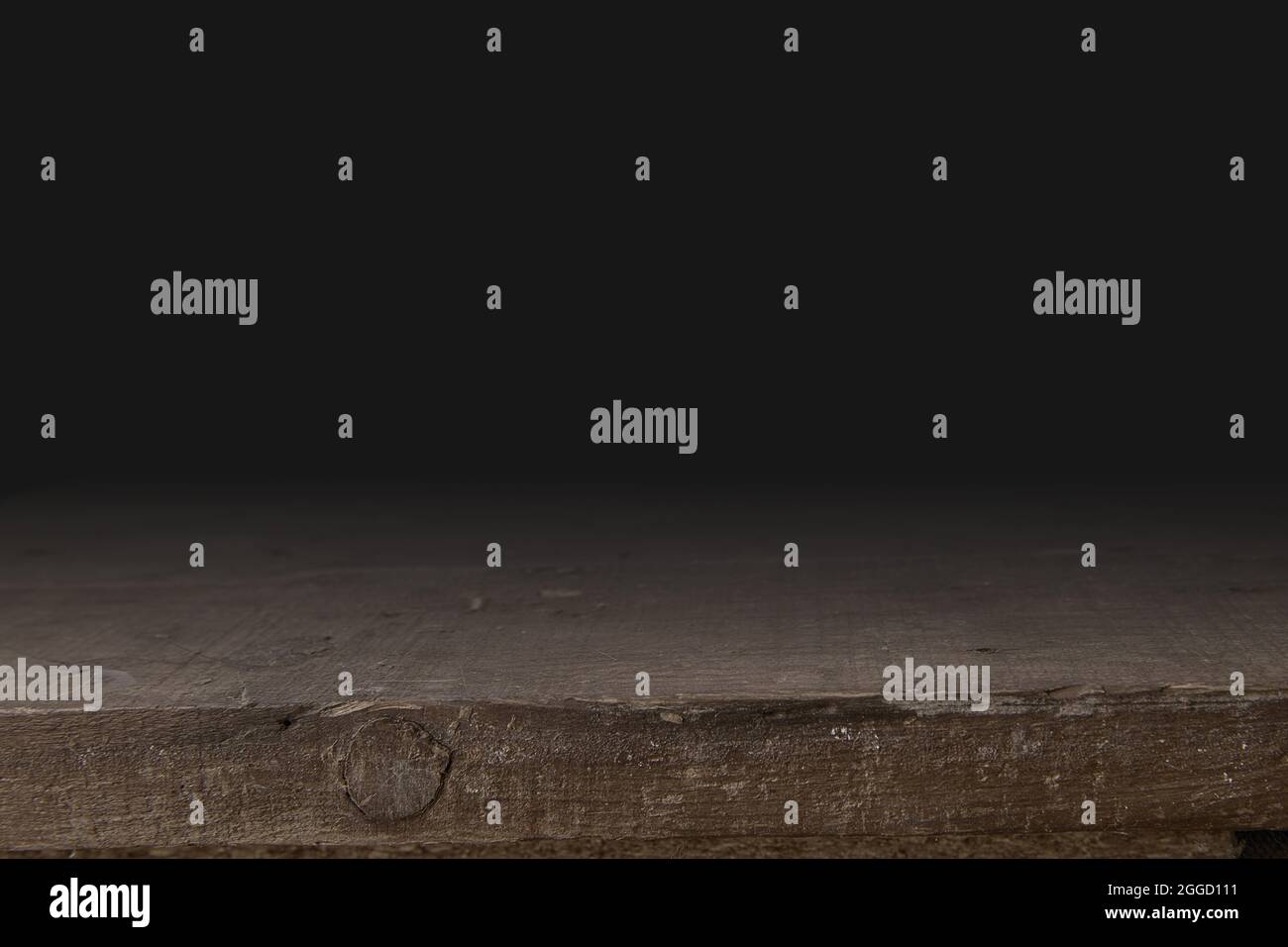 Wooden table with dark background Stock Photo - Alamy