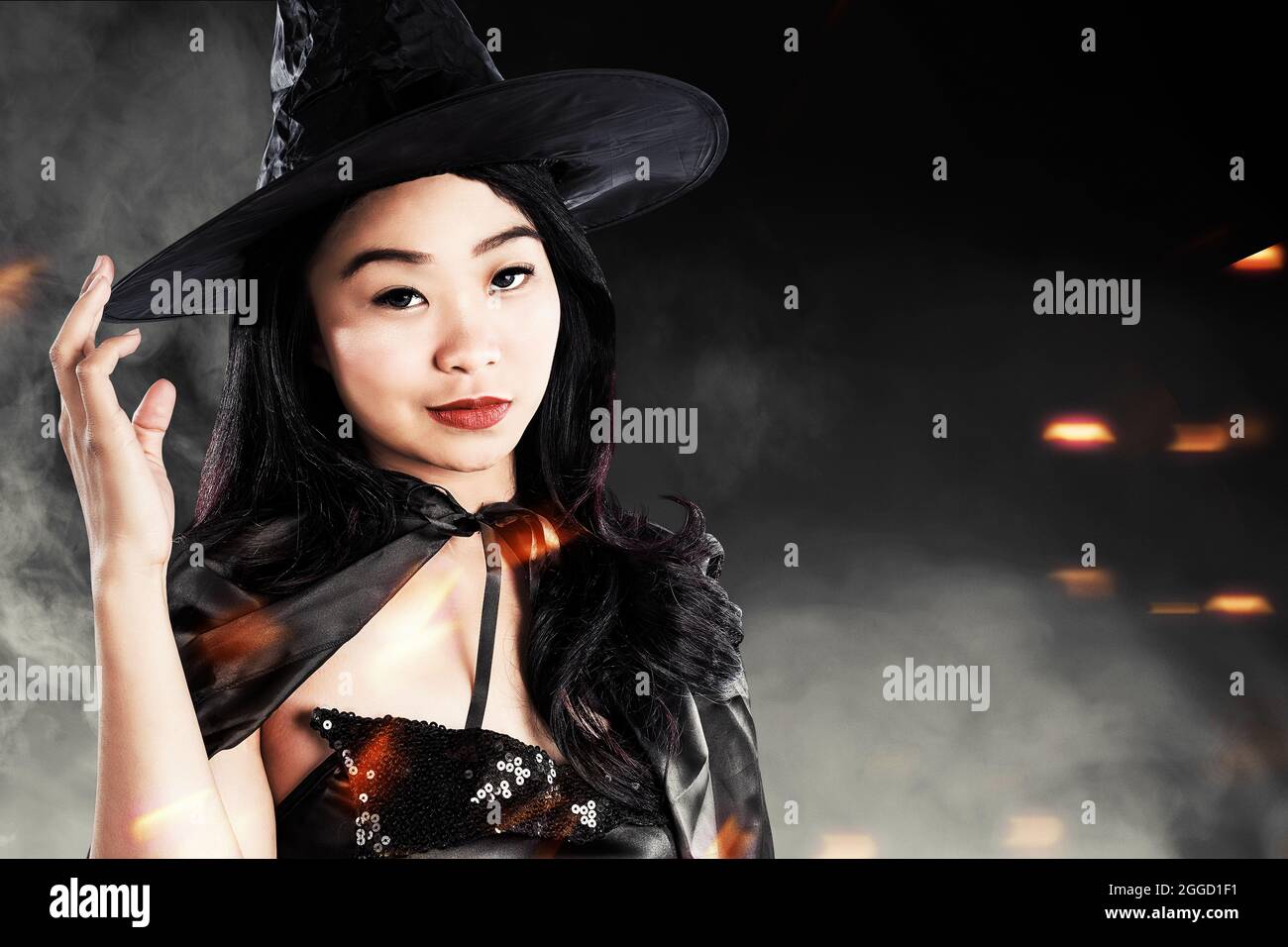 Asian witch woman with a hat standing with a black background Stock ...