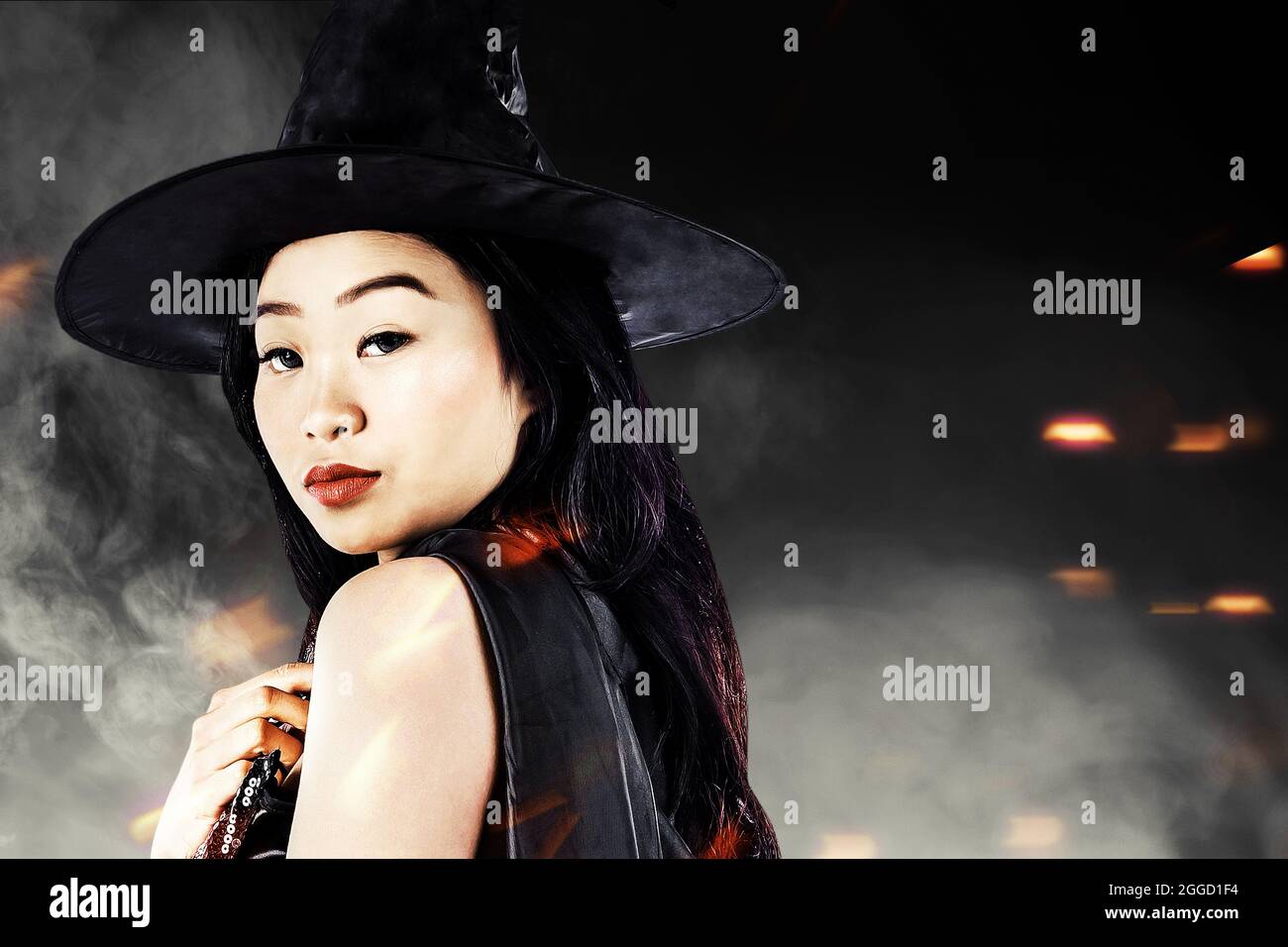Asian witch woman with a hat standing with a black background Stock ...