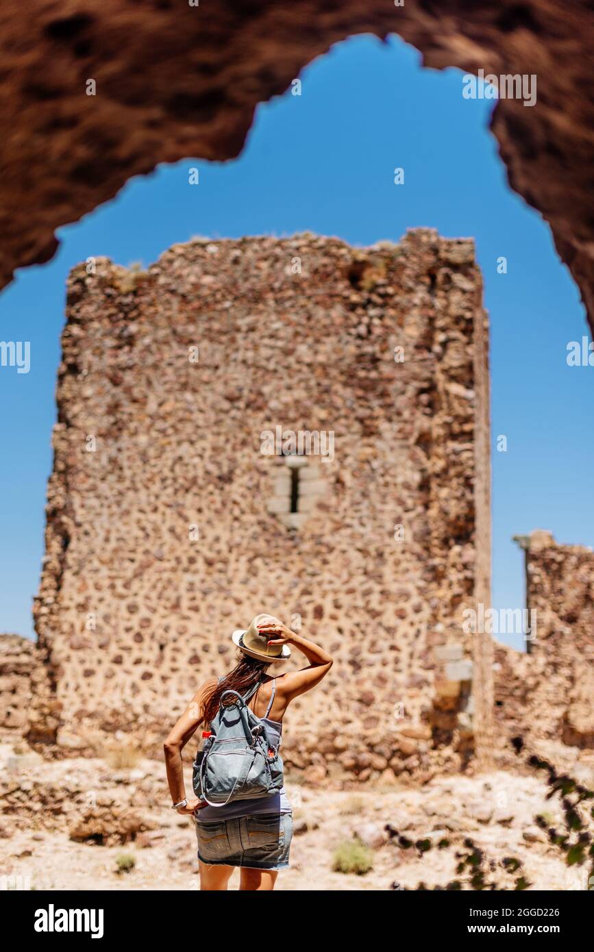 Tourist looking at the wall of a medieval castle Stock Photo - Alamy