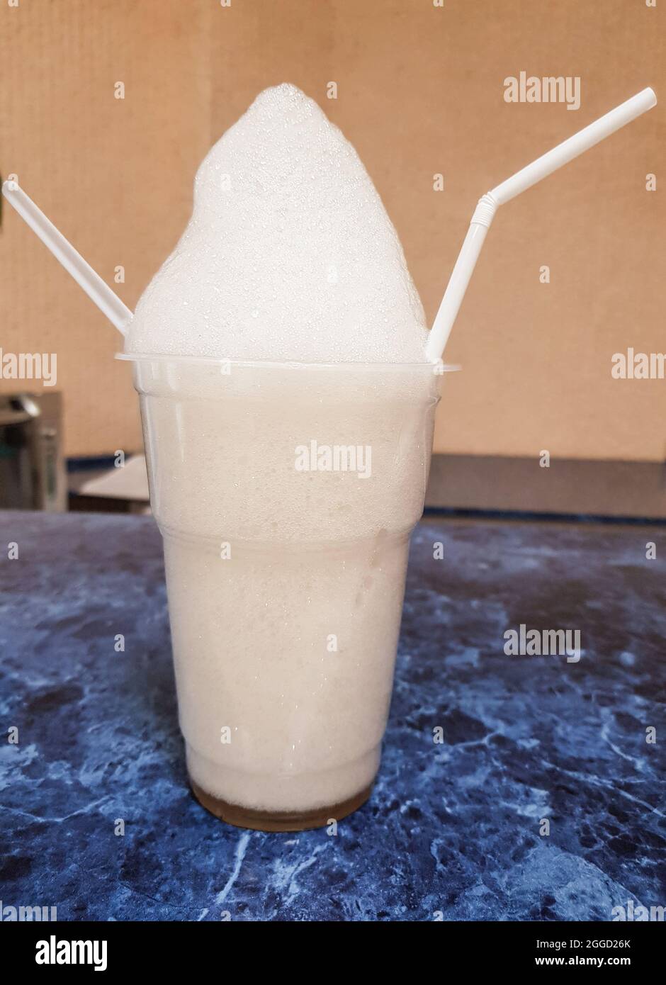 Oxygen cocktail with a straw and a spoon in a plastic cup, a useful ...