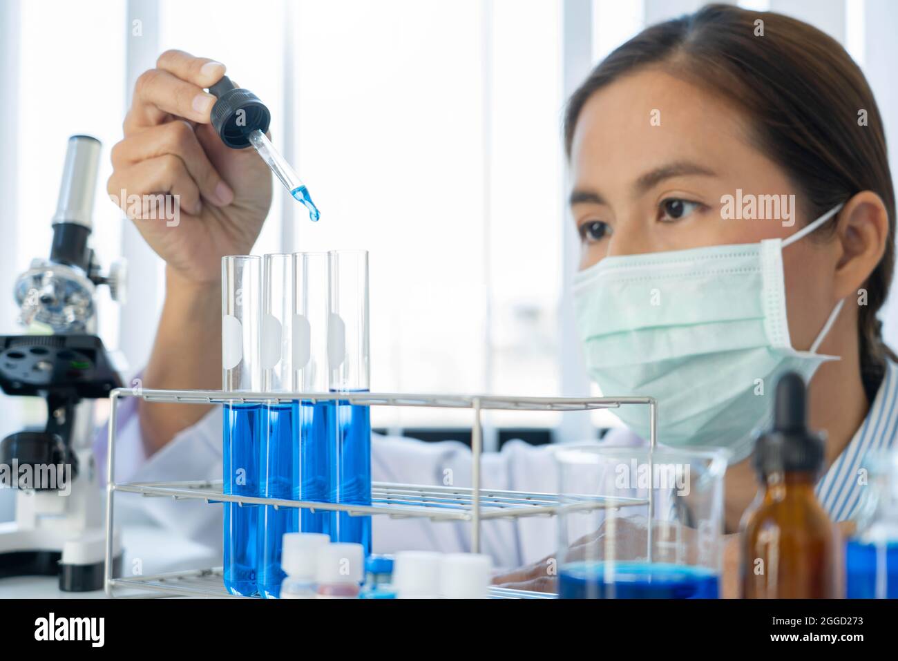 Scientist wear lab coat and protective wear are working with research ... Scientist wear lab coat and protective wear are working with research ...
