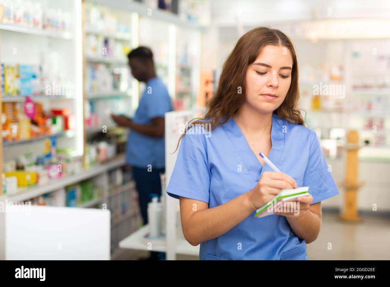 Portrait of a focused young female pharmacist making important work ...