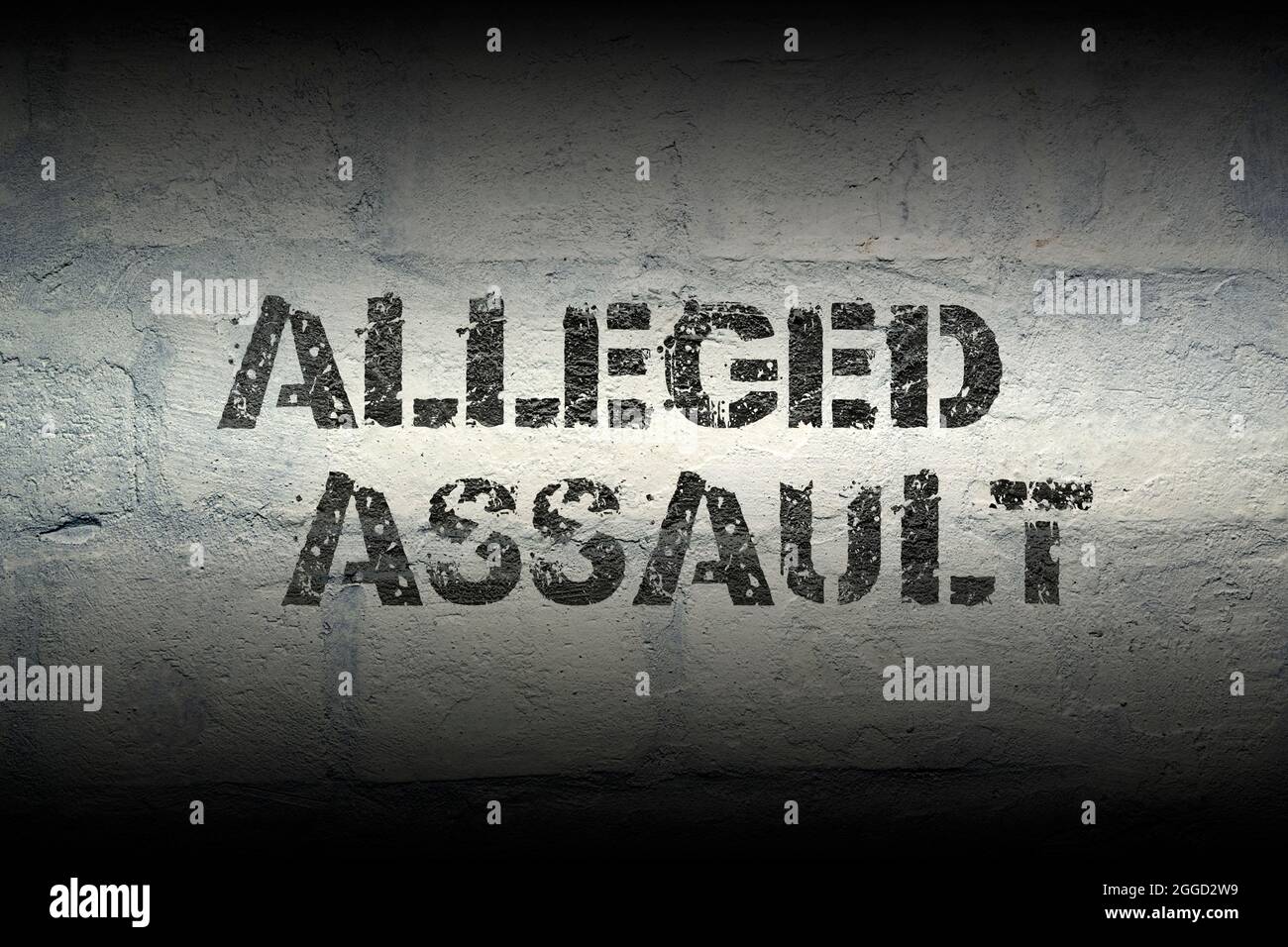 alleged assault stencil print on the grunge white brick wall Stock ...