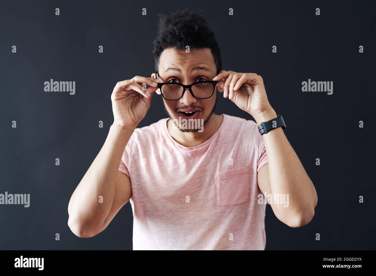 Emotional attractive male with opened mouth expresses great surprisment ...