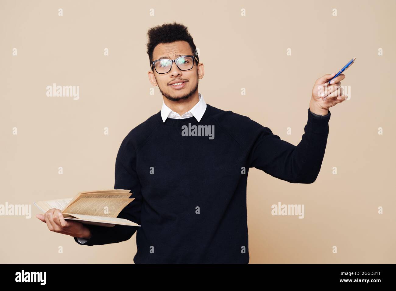 Young Professor holding a book while explaining wearing glasses on ...