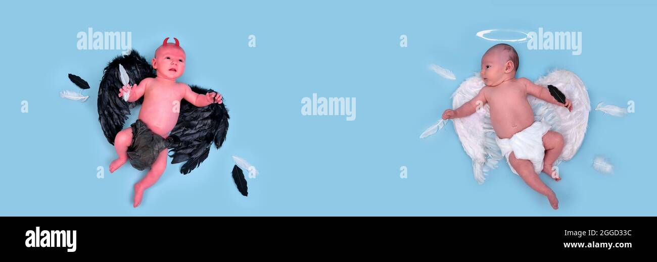 Angel and demon offer a choice, copy space. A newborn baby boy with ...