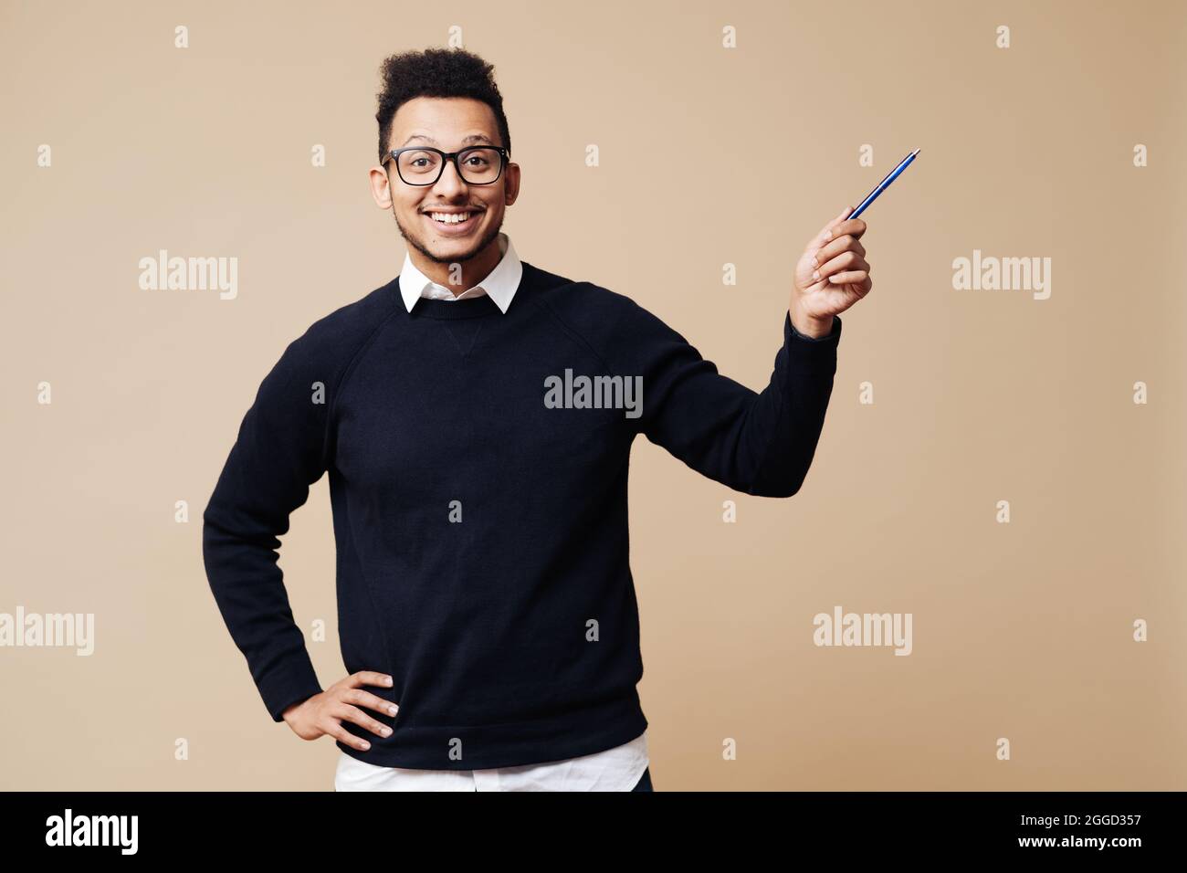 Young Professor pointing hand with pen to copy space while explaining ...