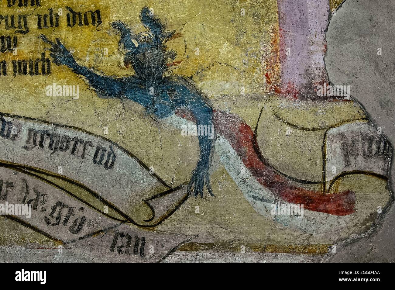 A blue-skinned demon points at a German inscription in this small ...