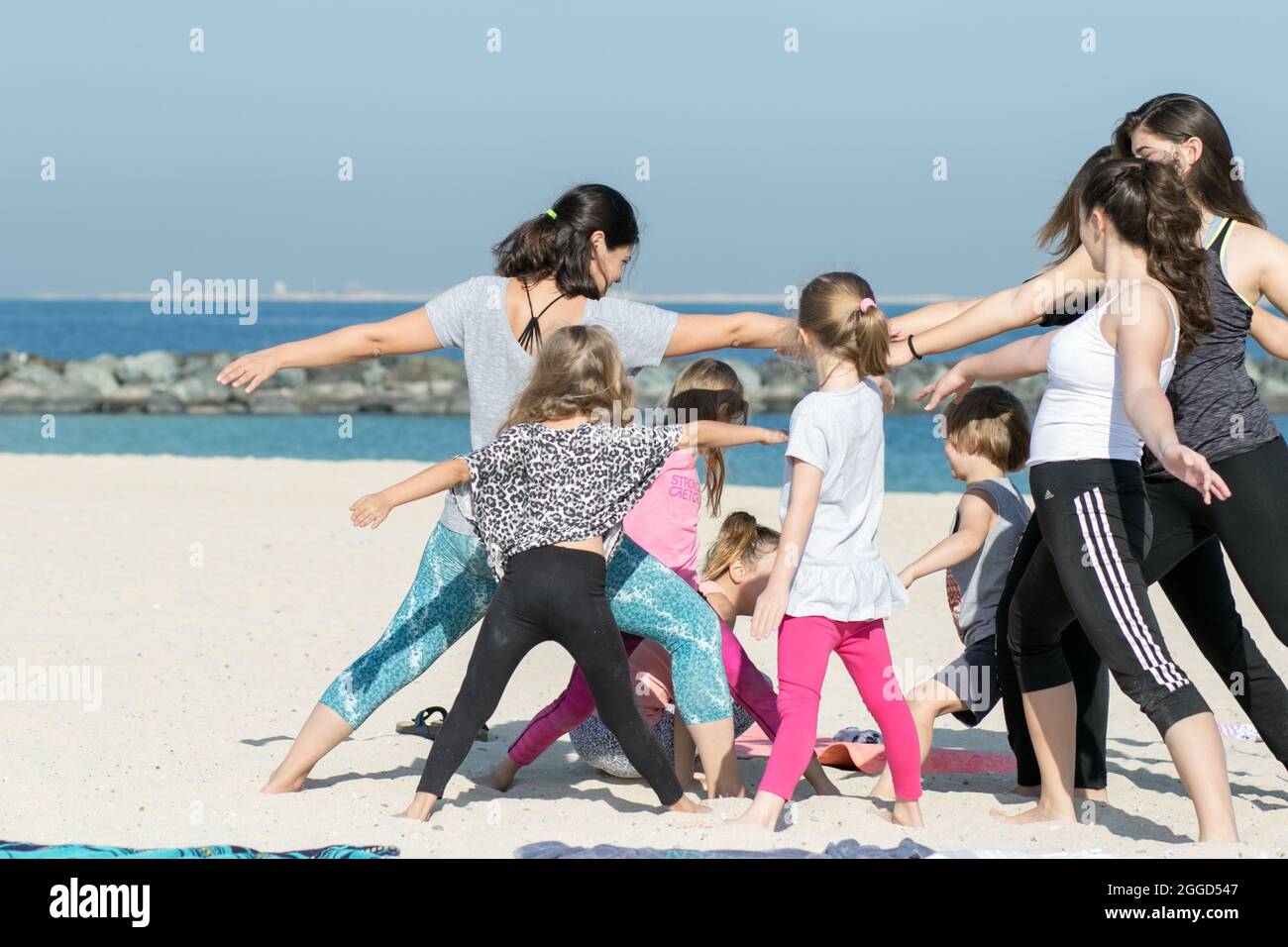 Young Children Doing Exercises Outdoor on the Beach with White Sand ...