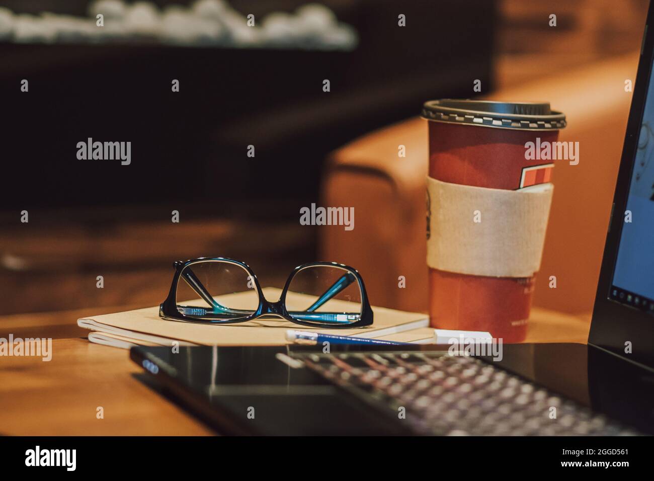 Working Environment Wooden Desk with Coffee and Laptop with Notebook ...