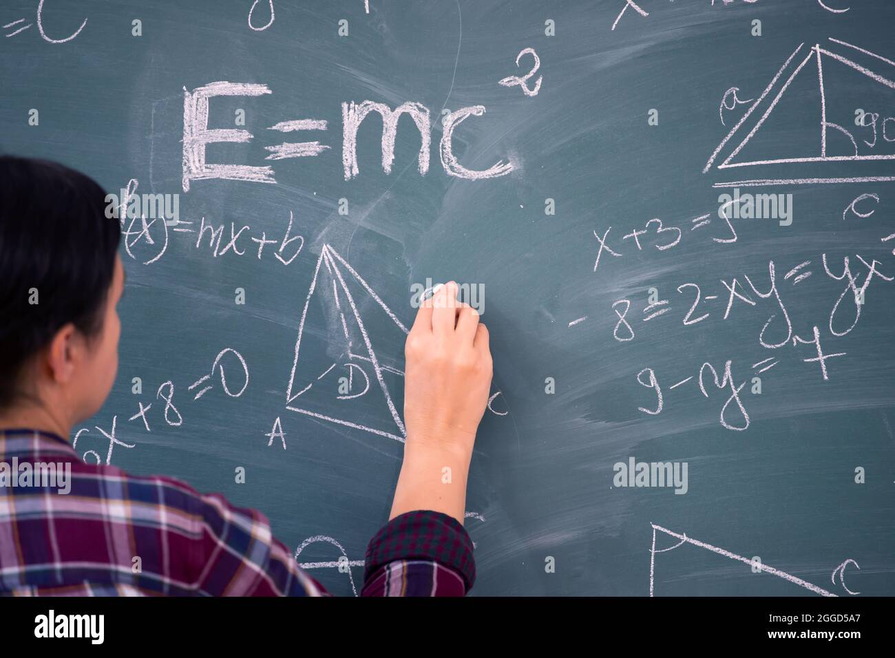 Teacher or student writing on blackboard during lesson and lecture in ...