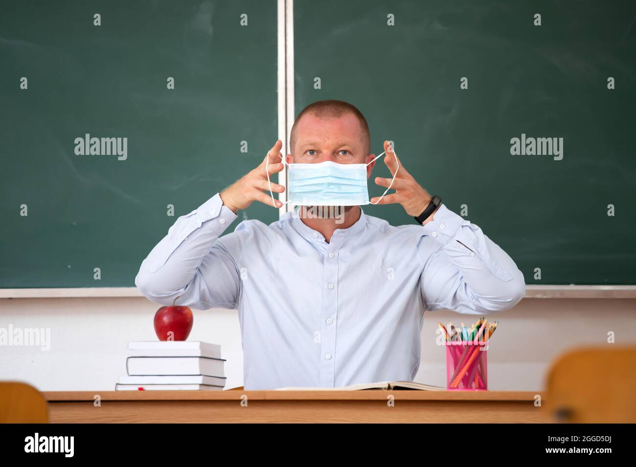 Teacher with mask teaching how to wear mask at school. Social ...