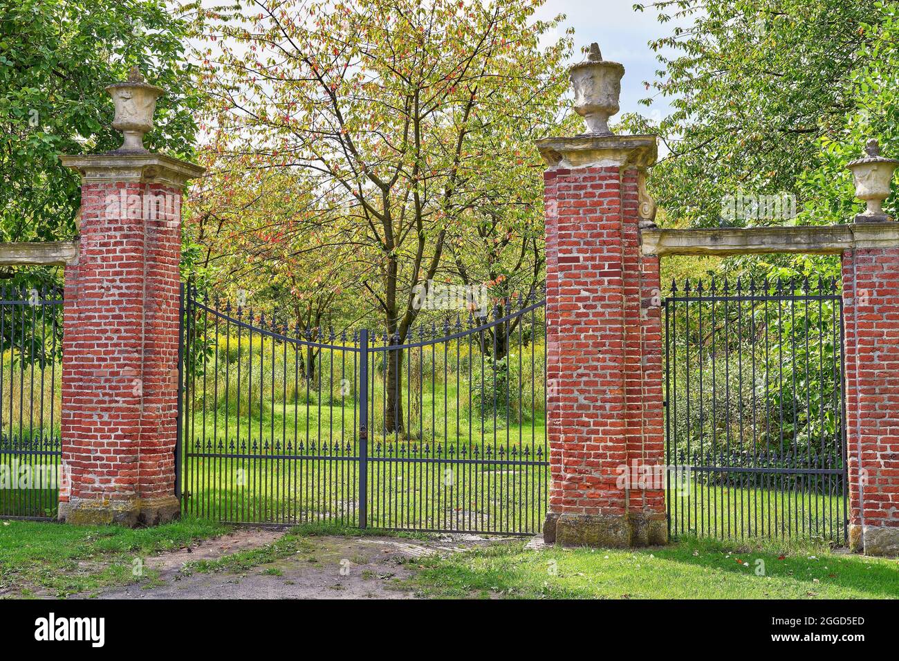 Wrought iron entrance gate to the garden. Brick pillars and sandstone ...
