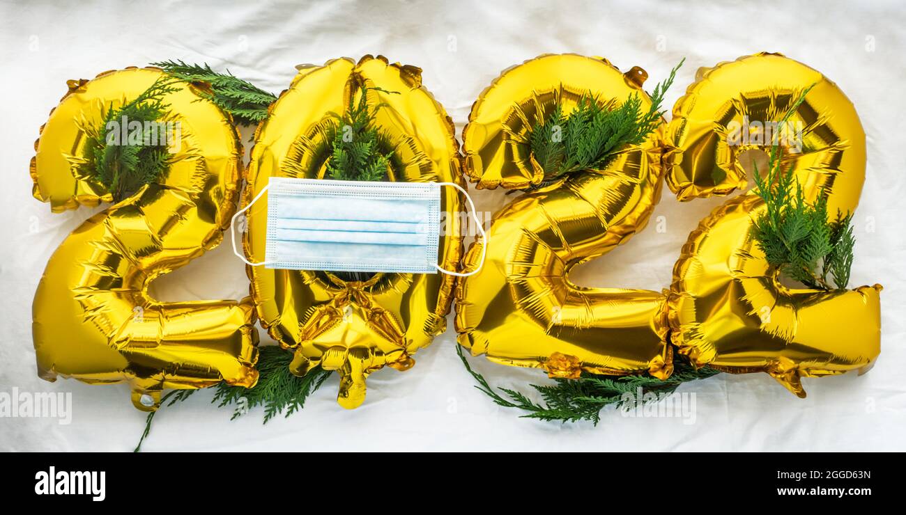 2022 new year numbers balloons on white with face masks Stock Photo - Alamy
