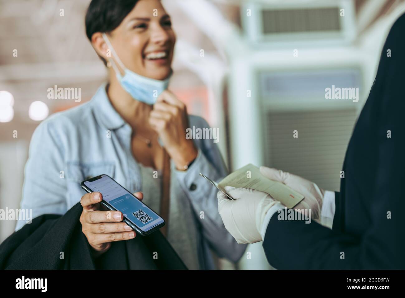 Woman in covid-19 pandemic holding her face mask down for facial ...