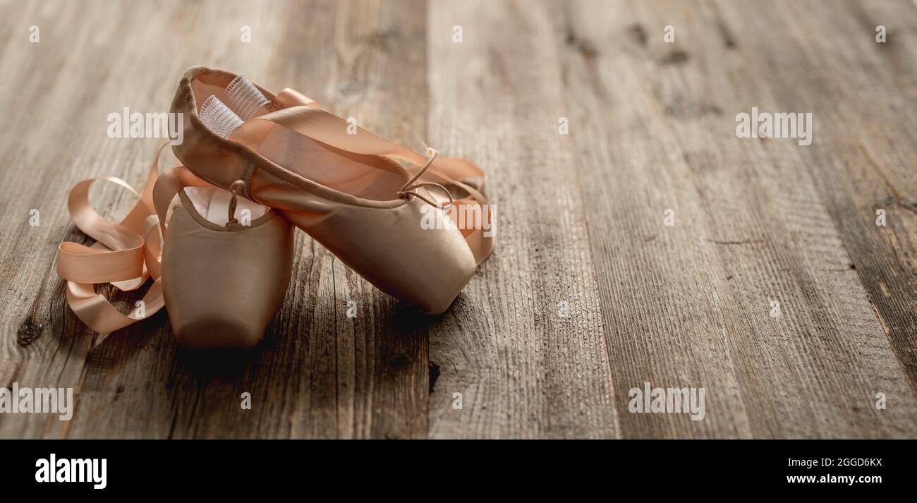 Pointe shoes with ribbons on wooden background Stock Photo - Alamy