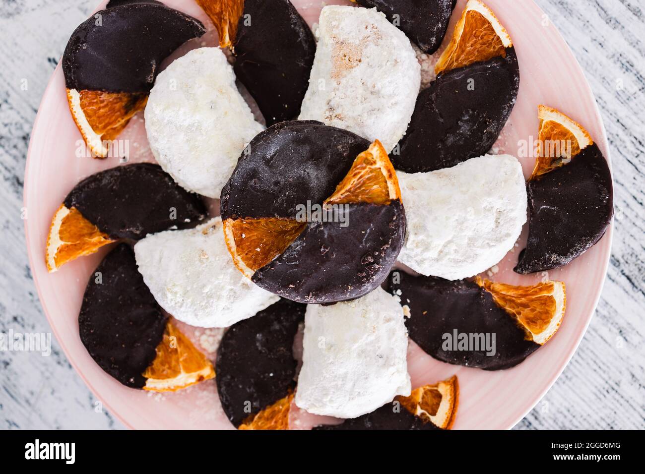 vegan almond crescent cookies and dehydrated orange slices covered in ...