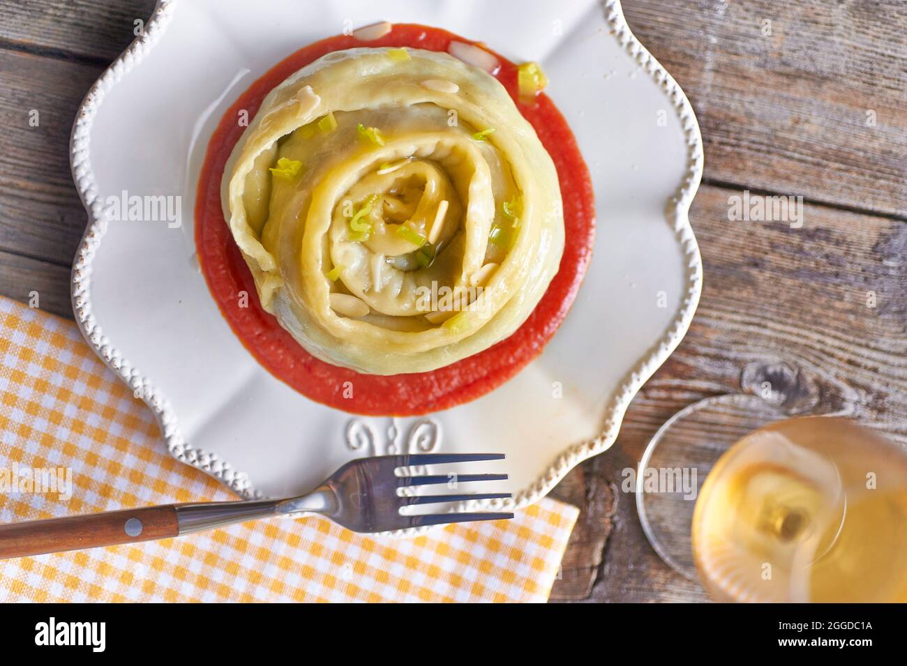 Roll pastry with nettle filling and tomato sauce Stock Photo - Alamy