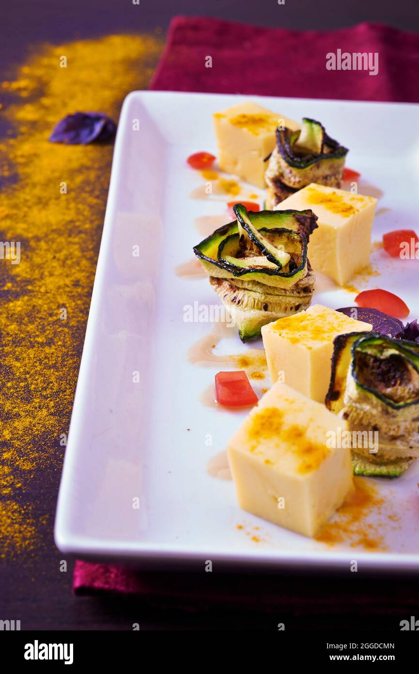 chickpea cheese with tumeric served with tomato zucchini, tahina and ...