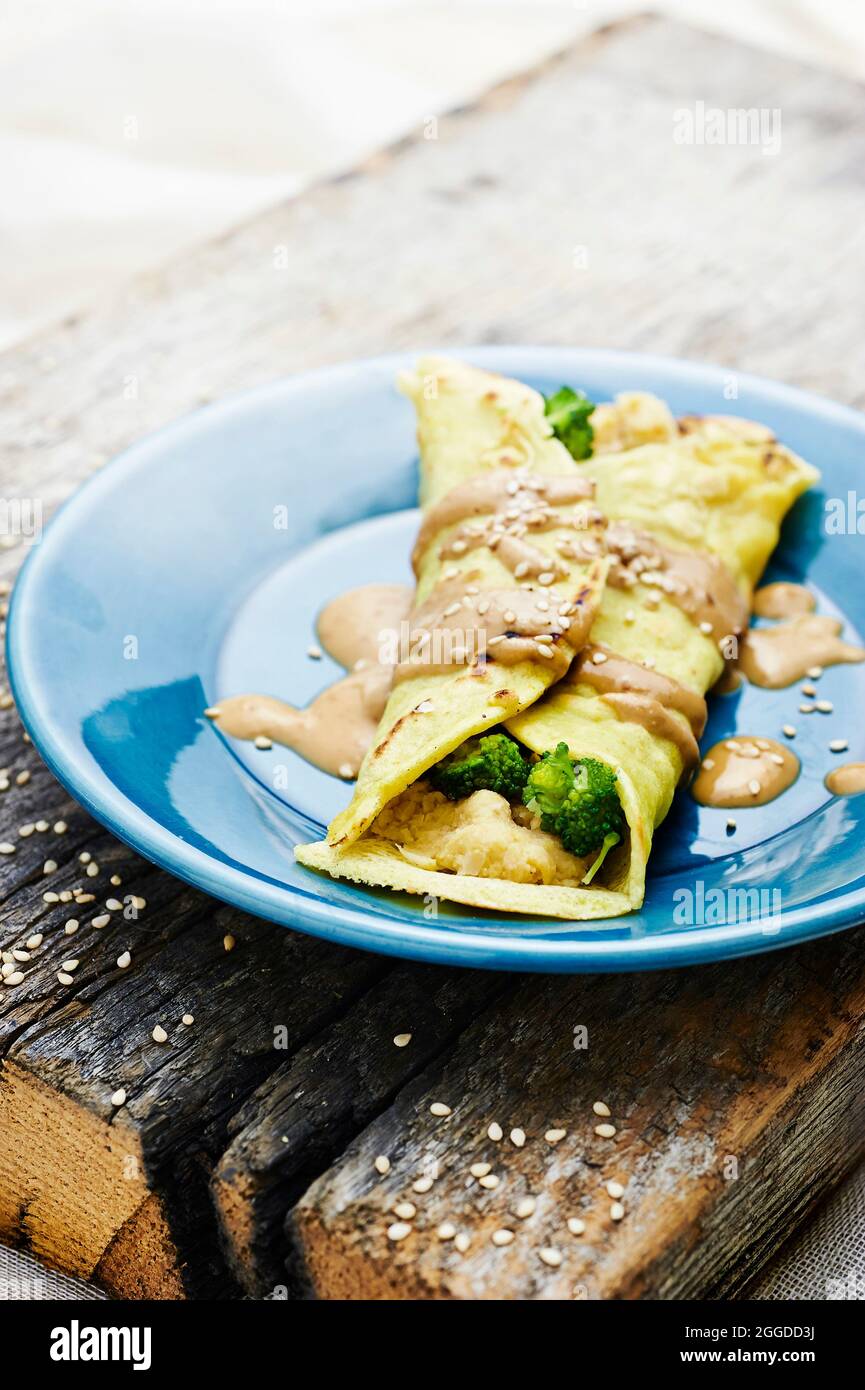 Broccoli and chickpea stuffed crepe with miso souce dressing and sesame ...