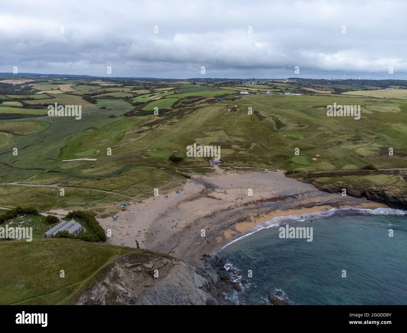 aerial drone around church cove and mullion golf course cornwall uk ...