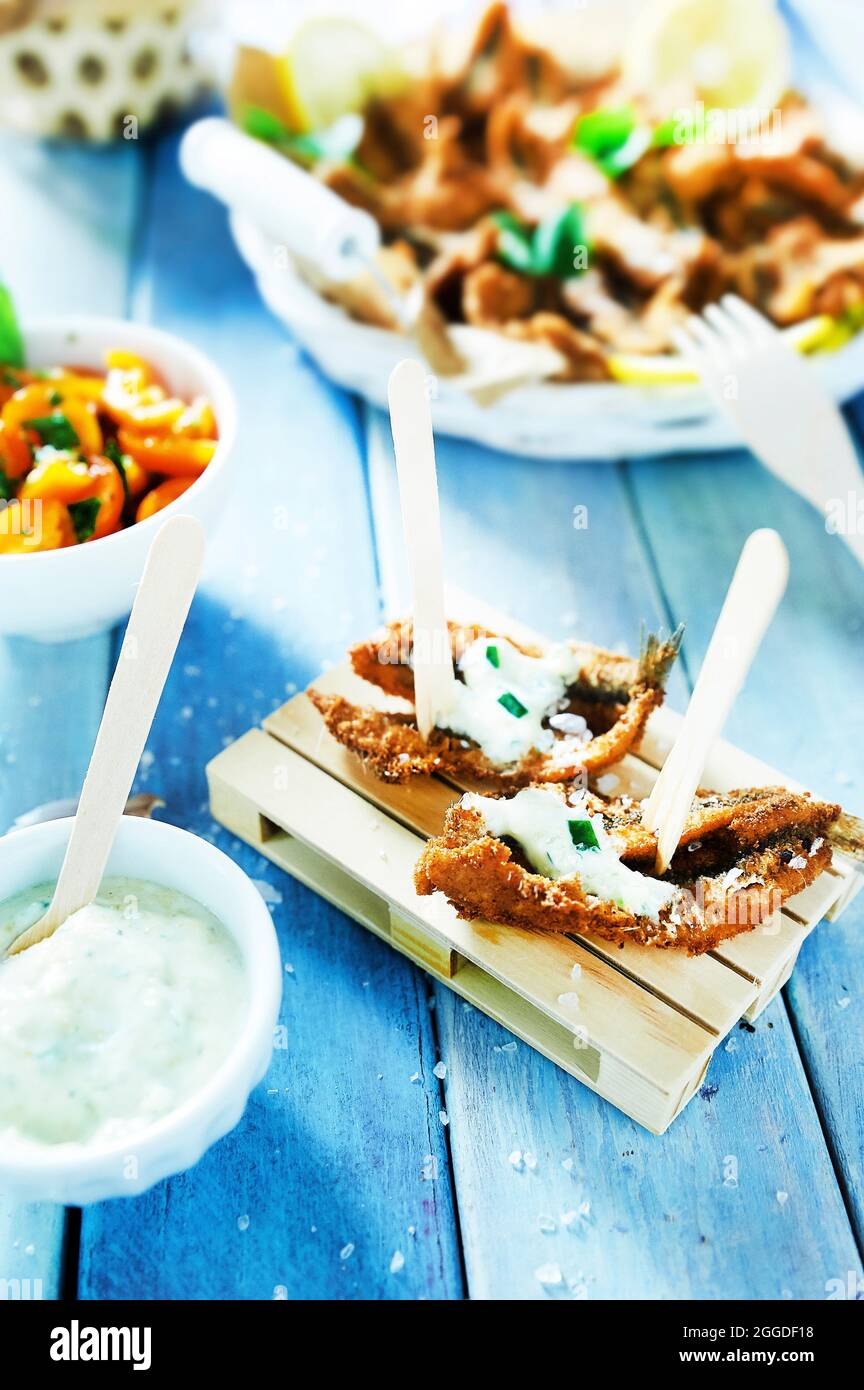 Fried anchovy, tomatoes, vegan tzatziki Stock Photo - Alamy