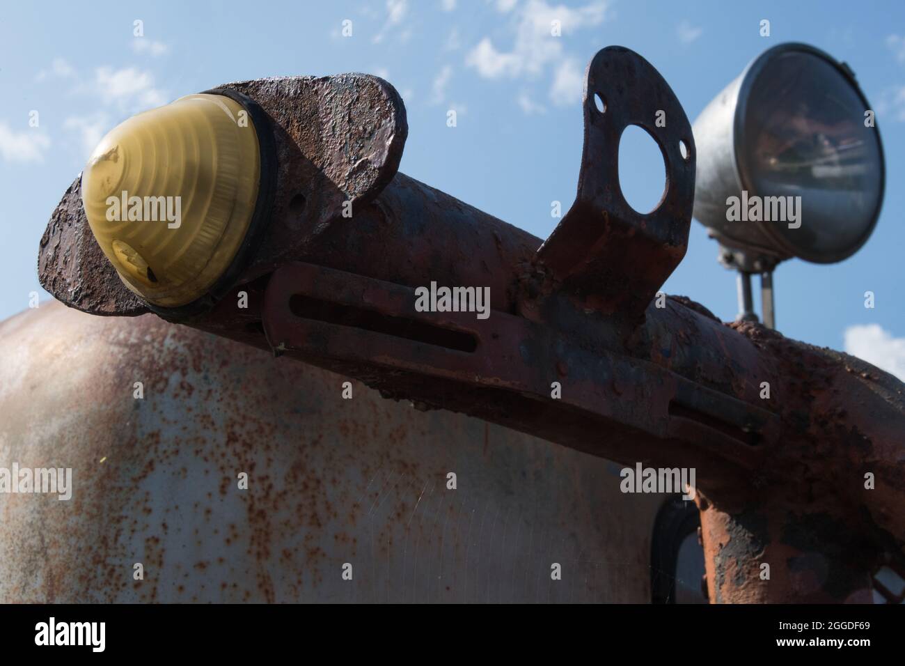 close-up of the boundary light and horn of an old rusty scraper wagon ...