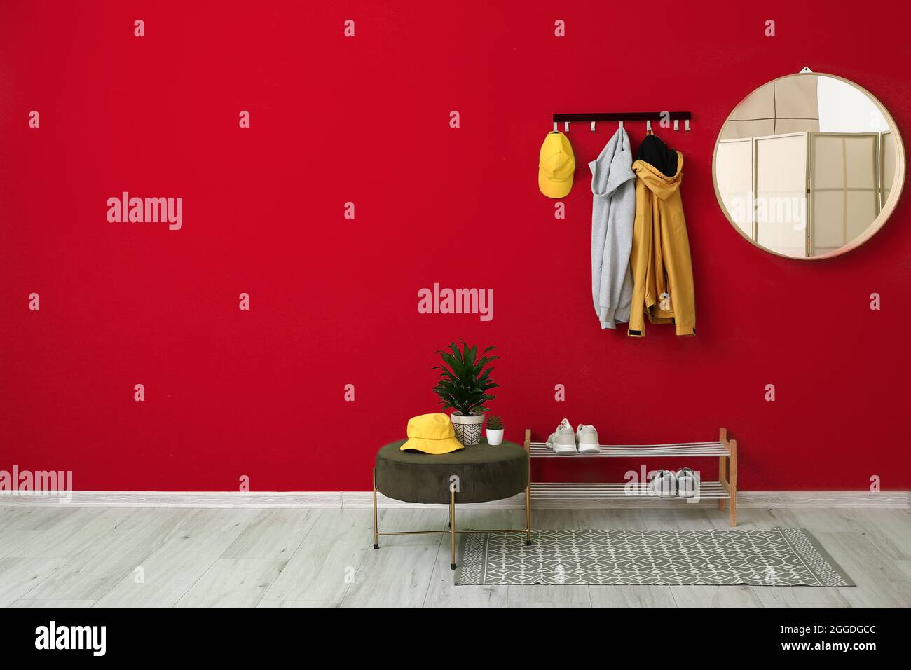 Stylish interior of modern hall with red wall Stock Photo - Alamy