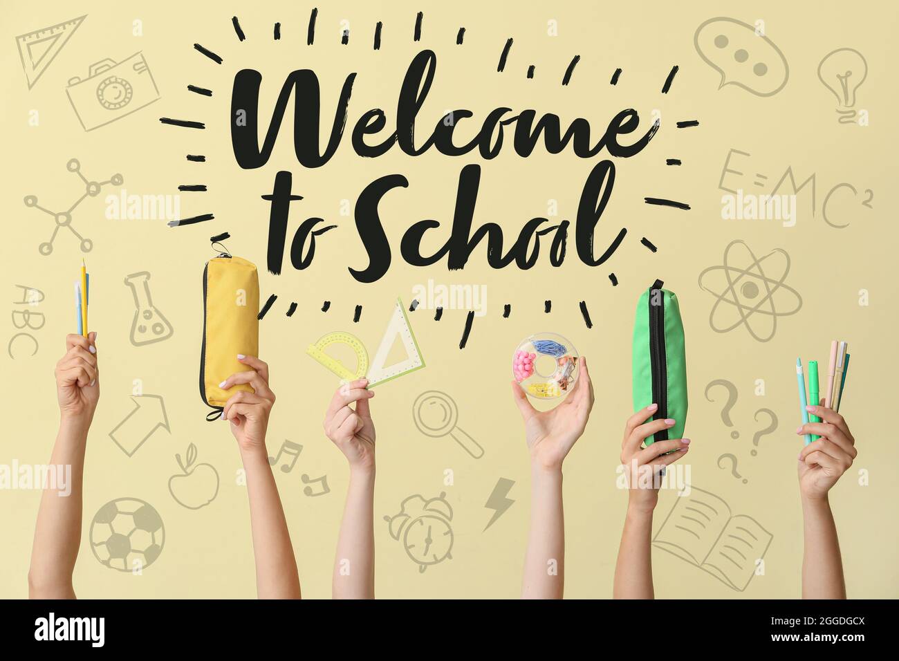 Hands of pupils with stationery and text WELCOME TO SCHOOL on color ...