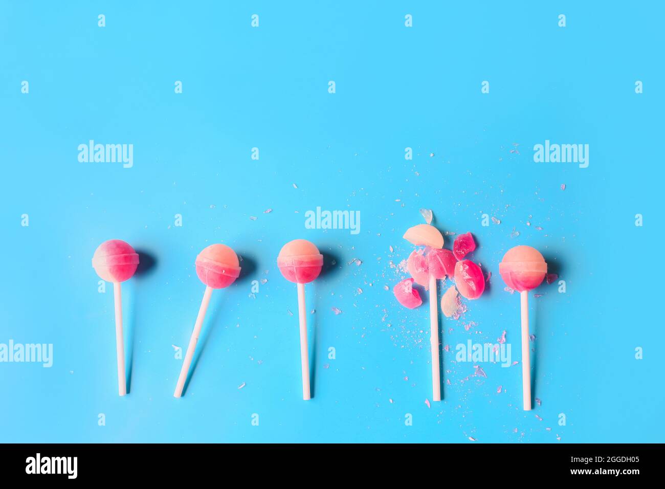 Broken lollipop among whole ones on color background. Concept of ...
