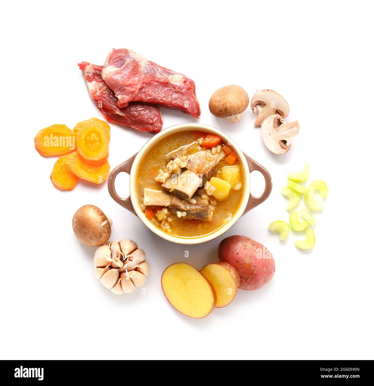 Pot of beef barley soup and ingredients on white background Stock Photo ...