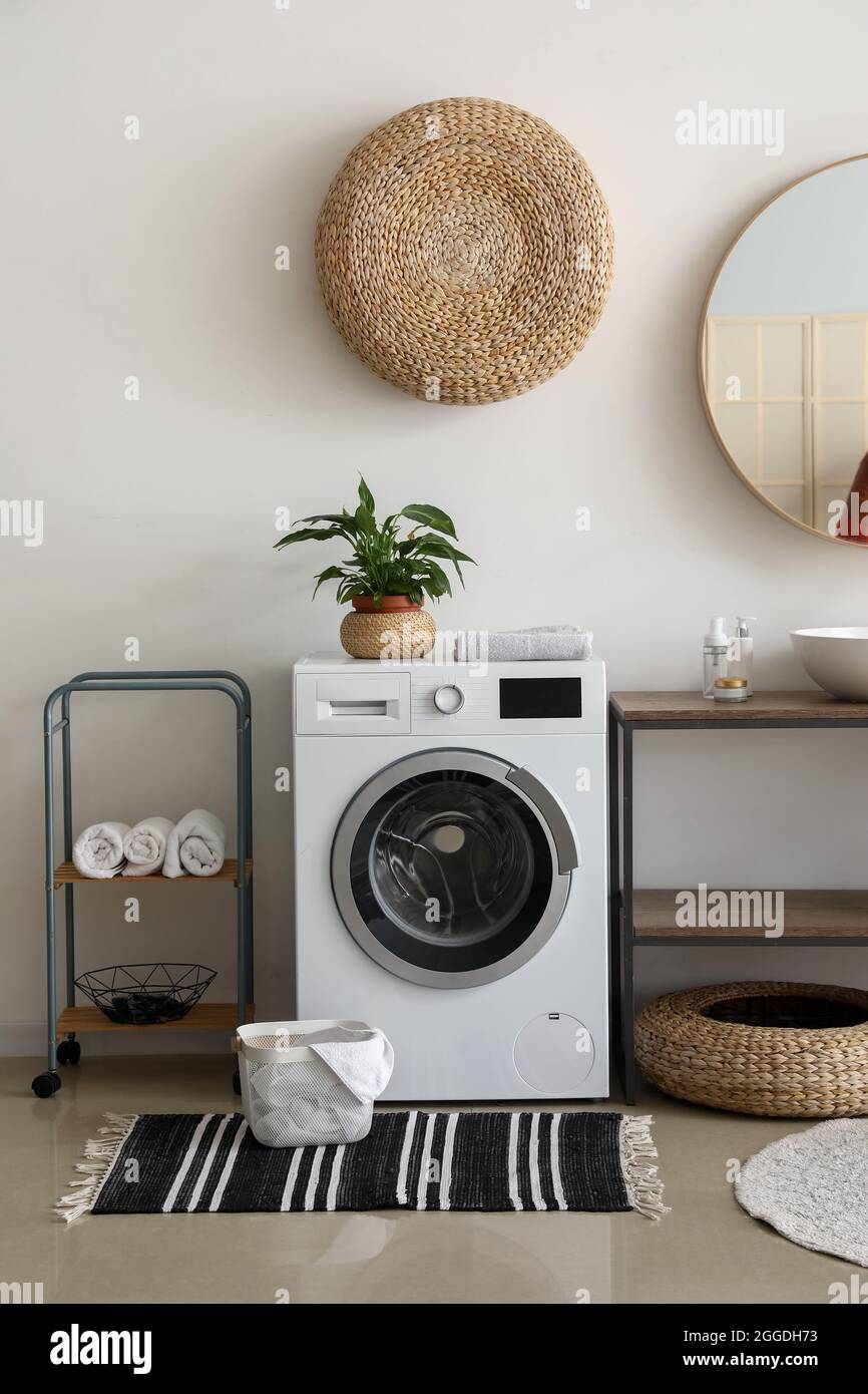 Interior of bathroom with modern washing machine Stock Photo - Alamy