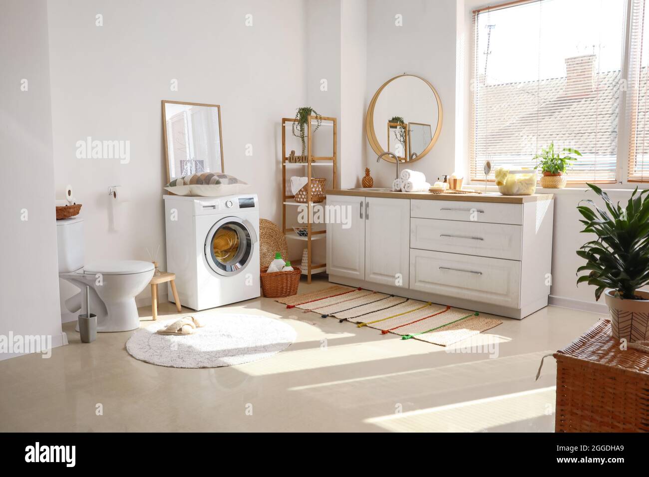 Interior of bathroom with modern washing machine Stock Photo - Alamy