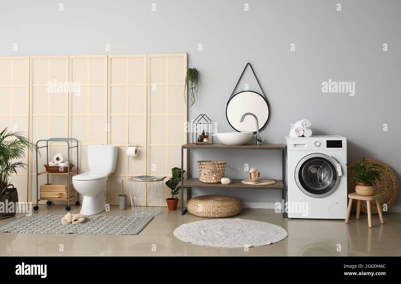 Interior of bathroom with modern washing machine Stock Photo - Alamy