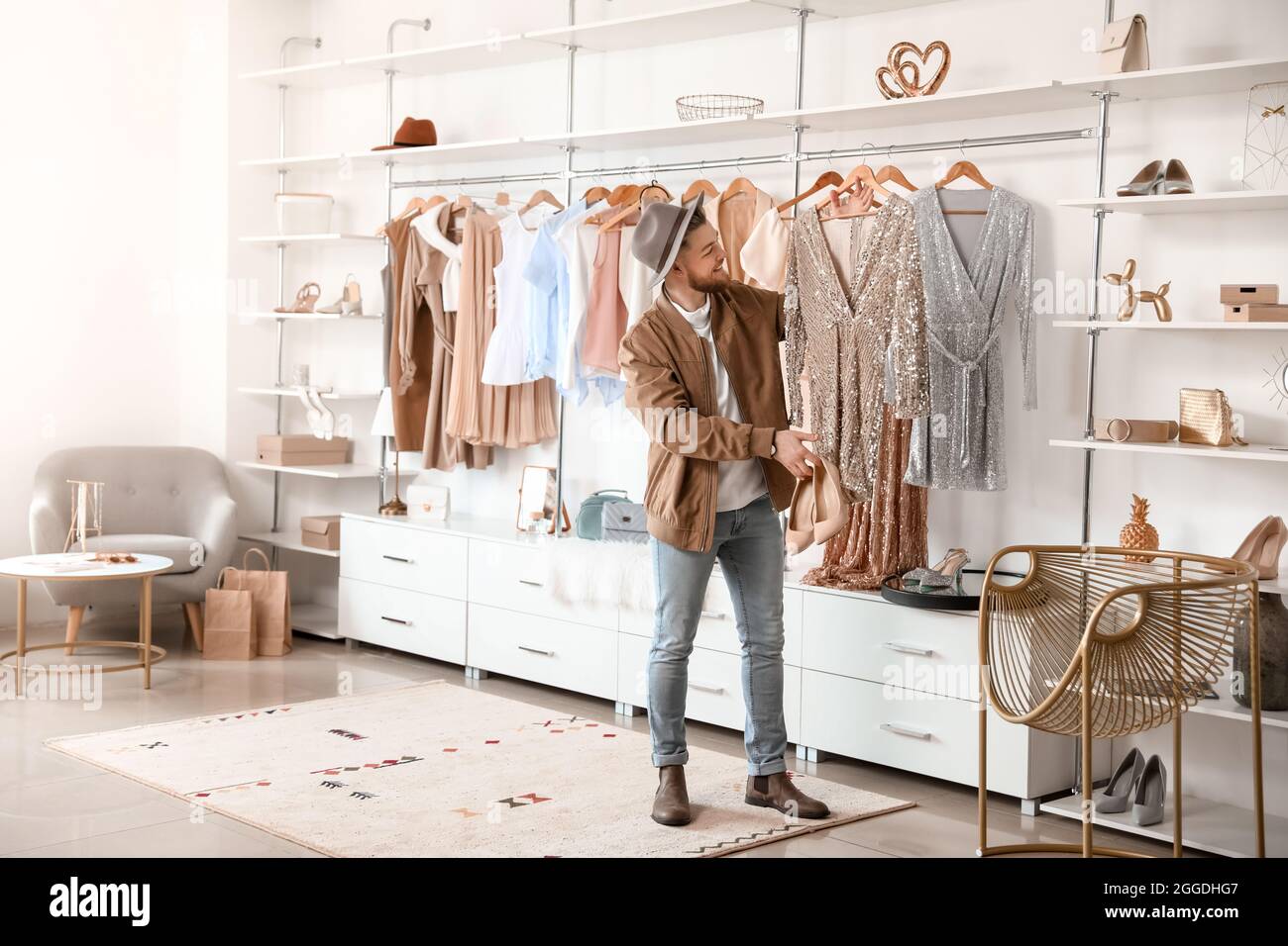 Male stylist with clothes in studio Stock Photo - Alamy