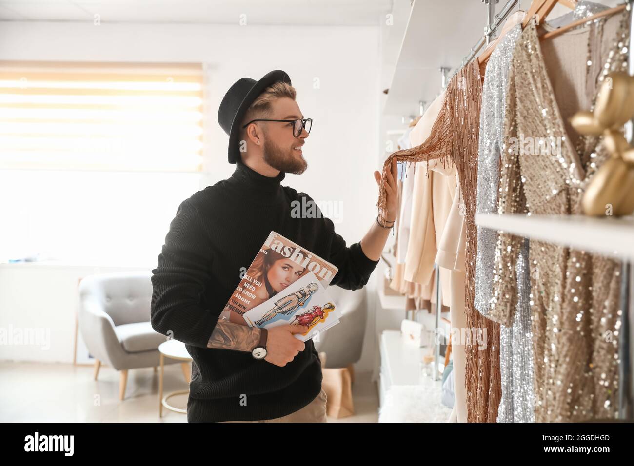 Male stylist working in studio Stock Photo - Alamy