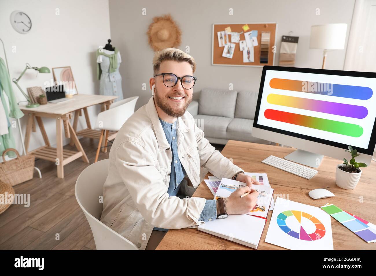 Male stylist drawing sketch in studio Stock Photo - Alamy