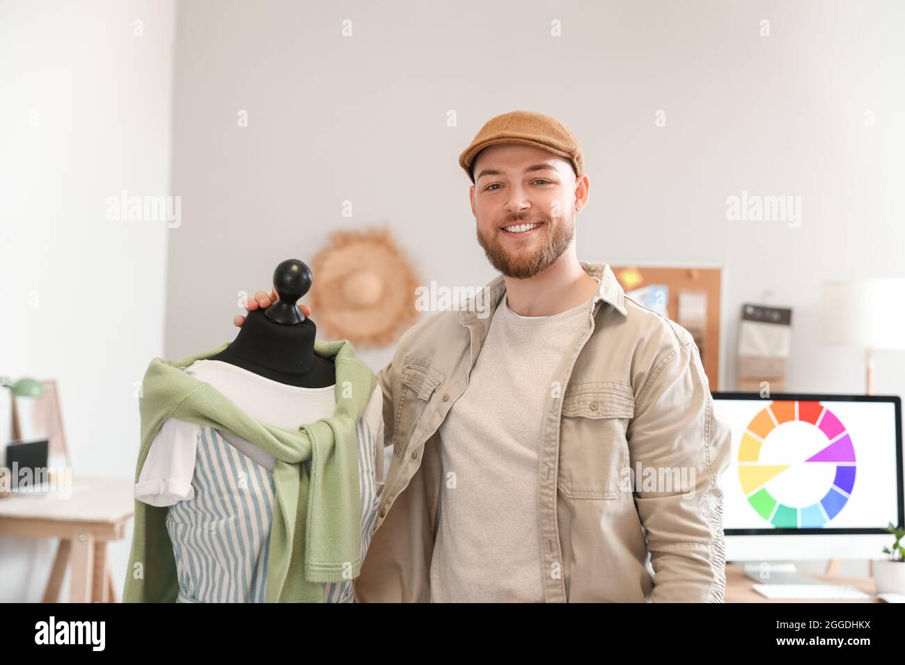 Male stylist with mannequin in studio Stock Photo - Alamy
