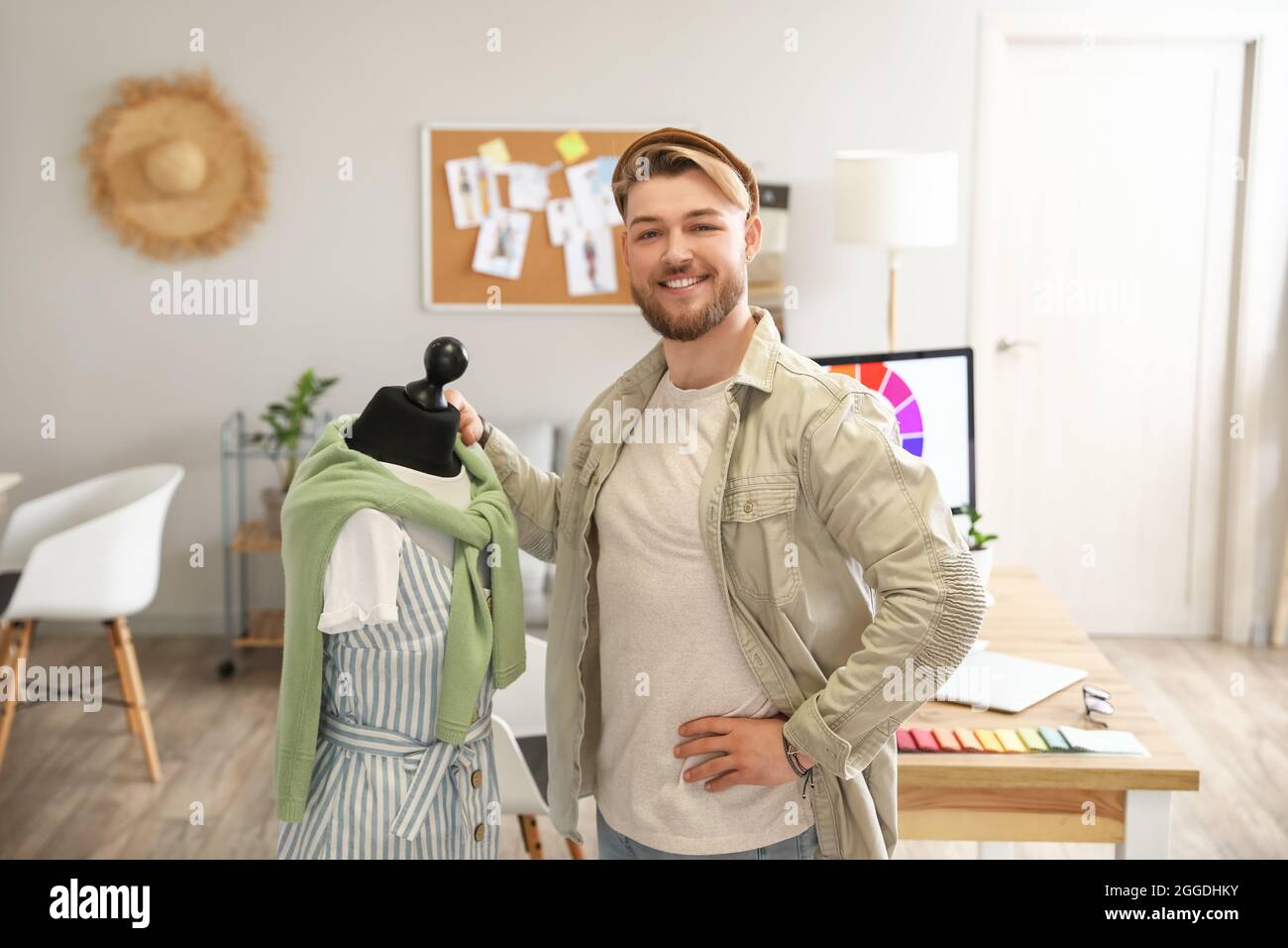 Male stylist with mannequin in studio Stock Photo - Alamy