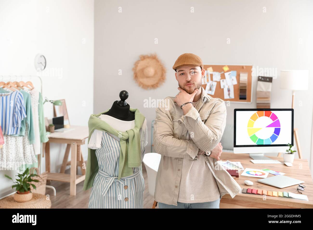 Male stylist with mannequin in studio Stock Photo - Alamy