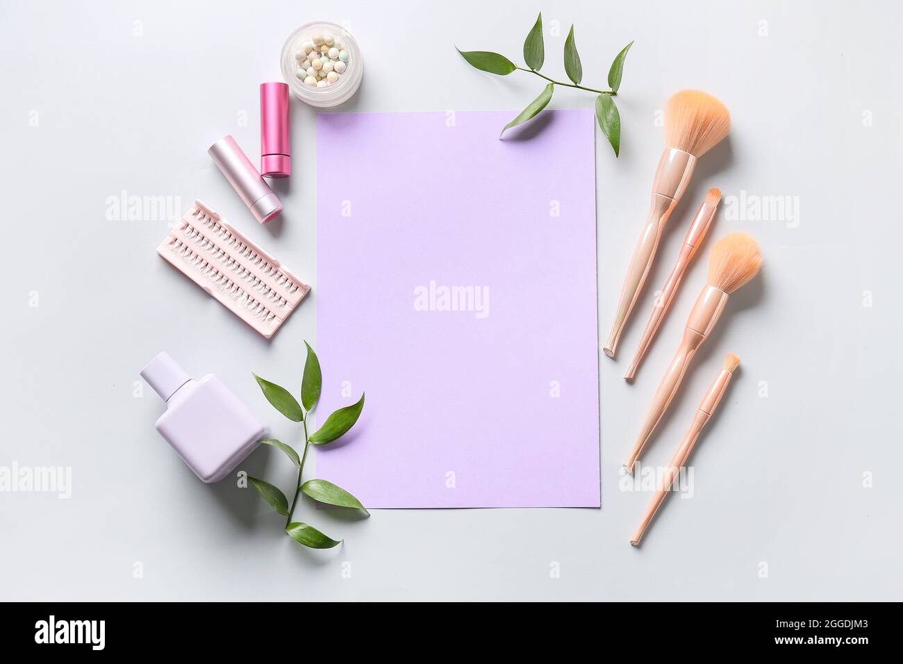 Composition with blank sheet of paper, makeup brushes and cosmetics on ...