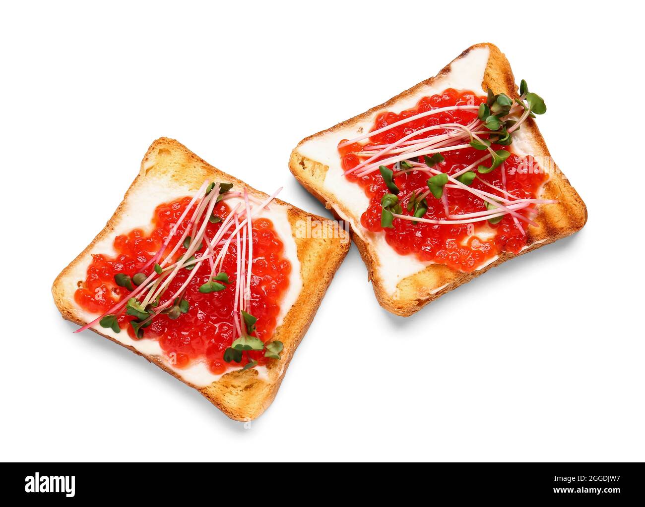 Tasty toasts with red caviar and micro green on white background Stock ...